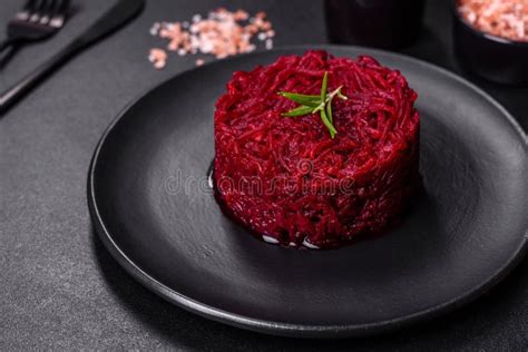 Cooked Grated Beetroot Formed As A Cylinder And Ready Dish On A Black