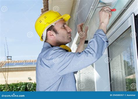 man installing roller shutter above doors stock image image of doors
