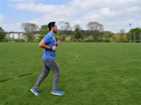 Premium Photo Side View Of Man Jogging On Field At Park