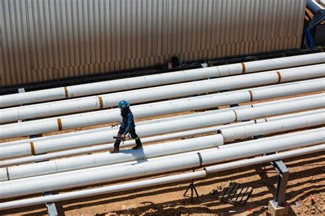Premium Photo Top View Male Worker Steel Long Pipes And Pipe Elbow New Construction Oil Tank