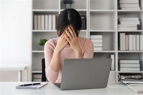 Premium Photo Bored Sleepy Asian Lady Sitting At Desk With Laptop