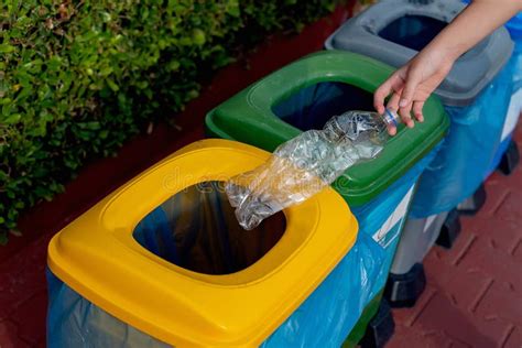 Close Up Hand Throwing Plastic Bottle Recycling Container Garbage