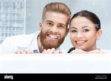 Portrait Of Smiling Scientists Looking Out Behind Table In Lab Stock Photo Alamy