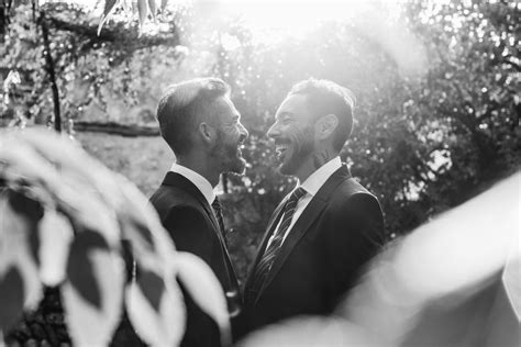 Two Grooms Celebrate Their Same Sex Marriage Smiling At Each Other In