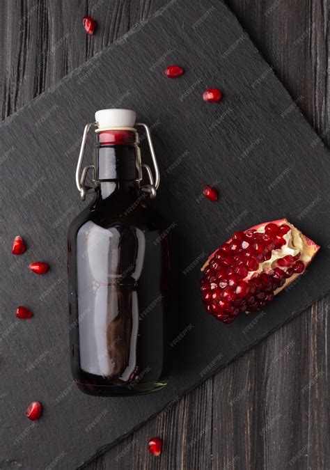 Premium Photo Broken Pomegranate And Pomegranate Juice In A Bottle On
