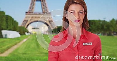 Confident Female Tour Guide Near Eiffel Tower Explaining Its History