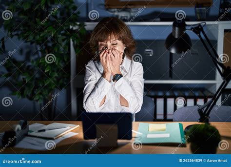 Middle Age Woman Working At The Office At Night Laughing And