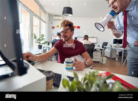 A Young Male Employee In A Uniform Atmosphere In The Office Being Woke