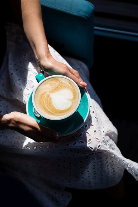 Female Hands Holding A Green Cup Of Coffee Cappuccino Manicure With