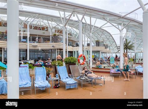 Adult Cruise Passengers Enjoying The Pool At The Solarium On The Royal