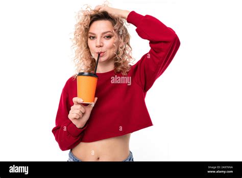 Caucasian Girl With Curly Fair Hair Drinks Coffe And Smiles Portrait