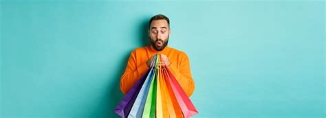 Homem Excitado Olhando Sacolas De Compras Com Compras Em Pé Se