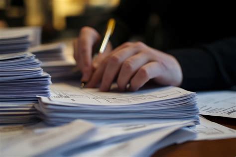 Person Sorting Through A Stack Of Documents Premium Ai Generated Image