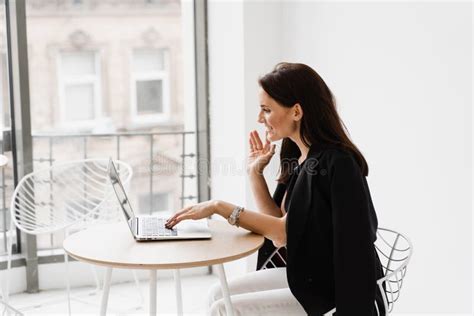 Confident Girl With Laptop Communicates And Talks About Herself Via Video Communication In Cafe