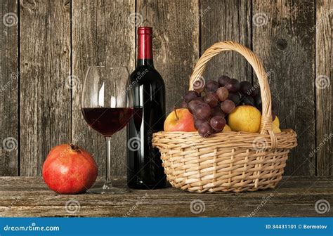 Still Life Bottle Of Wine Glass And Basket With Fruit Stock Image