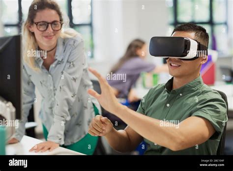 Computer Programmers Testing Virtual Reality Simulator Glasses In