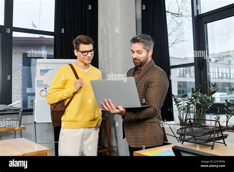 Two Colleagues Engage In An Active Onboarding Session In A Stylish Two Colleagues Engage In An Active Onboarding Session In A Stylish