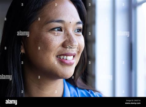 At Office Biracial Businesswoman Wearing Blue Shirt Smiling Gently