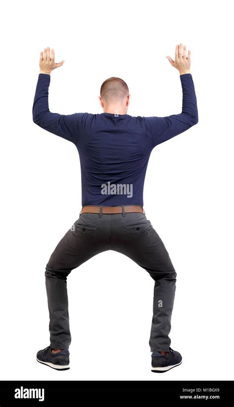 Back View Man Protects Hands From What Is Falling From Above Man
