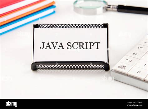 Javascript Displayed On A Desk With A Calculator A Notepad And A