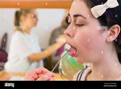 The Speech Therapist Makes A Tongue Massage To The Patient By A Special