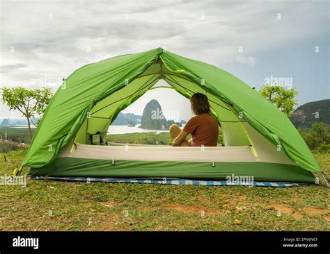Traveler Woman Sitting Inside Tent Admiring Scenery Of Phang Nga Bay