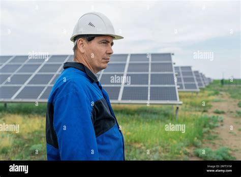 Service Engineer Man Standing In Front Of Solar Panels Technician
