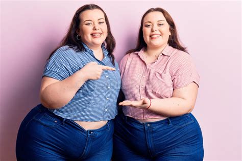 Young Plus Size Twins Wearing Casual Clothes Amazed And Smiling To The