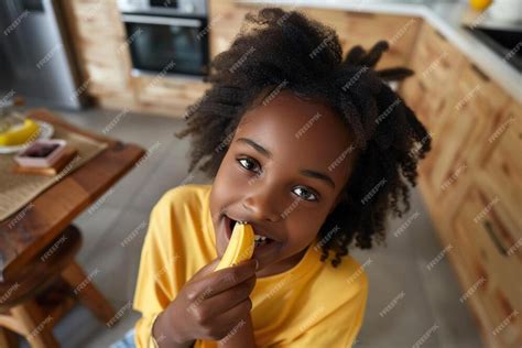 High Angle Girl Eating Banana Premium Ai Generated Image