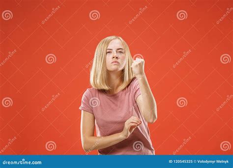 Portrait Of An Angry Woman Looking At Camera Isolated On A Red