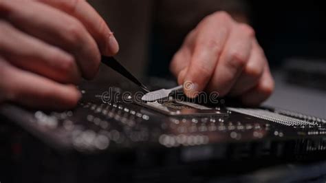 Computer Technician Meticulously Cleaning Off Leftover Thermal Paste From Cpu Socket On Computer