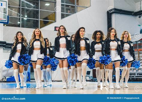 Cheerleaders In Mini Skirts And Knee Highs Holding Pom Poms Showing