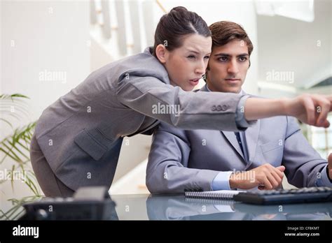 Businesswoman Explaining Computer Program To Colleague Stock Photo Alamy