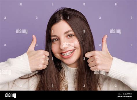 Portrait Of A Girl With Braces Woman Happy With Braces Shows Ok Sign