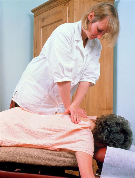 Chiropractor Presses On Spine Of A Woman Patient Photograph By Ron