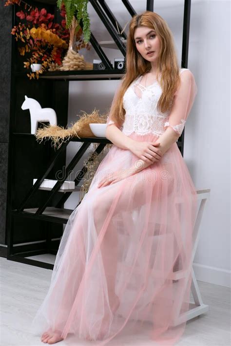 Delicate And Beautiful Girl Sitting On A Chair In An Elegant Boudoir