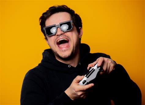 Premium Photo Man Sunglasses Plays With A Joystick