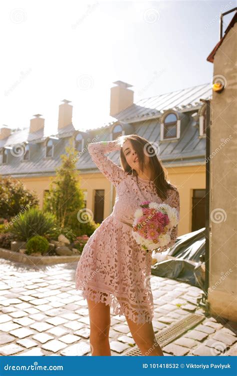 Beautiful Young Model Wearing Lace Pink Dress Posing In Rays Of Stock