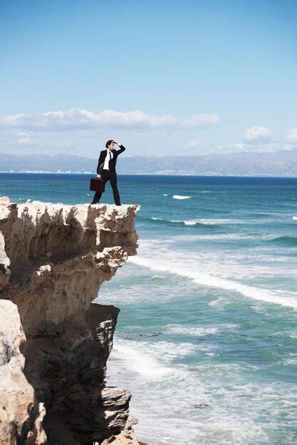 Premium Photo Thinking Cliff And Business Man On Edge By Ocean For Opportunity Problem Solving