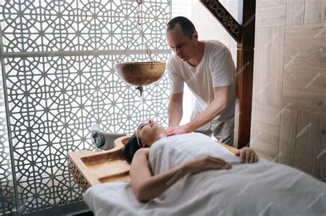 Premium Photo Professional Spa Master Applying Bandage To Forehead Of