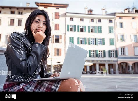 A Teenage Girl With Vitiligo Uses Her Laptop And Has A Thoughtful