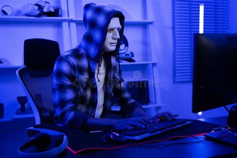 hacker is using laptop computer to steal data in the night stock image