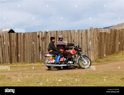 Mongol Men Dressed In Traditional Outfits Roam The Grasslands On Their