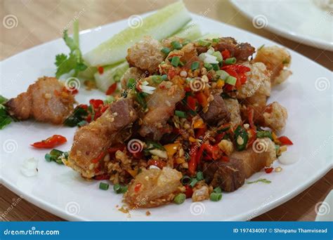 Stir Fried Pork Belly Slice With Chilli And Salt On A White Plate It