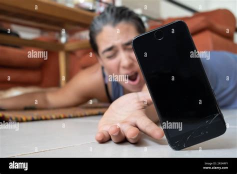 Cell Phone Crashes To The Floor In The Background An Out Of Focus