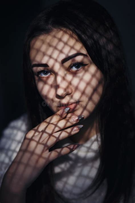 Beautiful Girl With A Light Pattern On The Face In The Form Of A Grid A Portrait Of Sensual