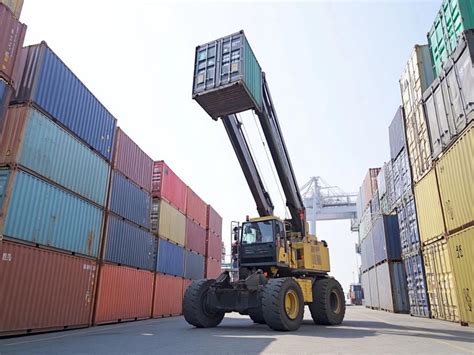 A Reach Stacker Lifting And Stacking Shipping Containers At A Container Terminal Premium Ai