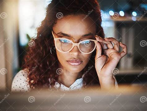 Whatever It Takes A Young Businesswoman Using A Computer During A Late