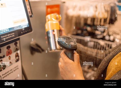 Girl Customer Scans Thermos Bottle At The Self Service Checkout In The Grocery Supermarket Shop