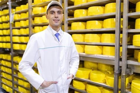 Free Photo Technologist In A White Coat Is In The Warehouse Of Cheese